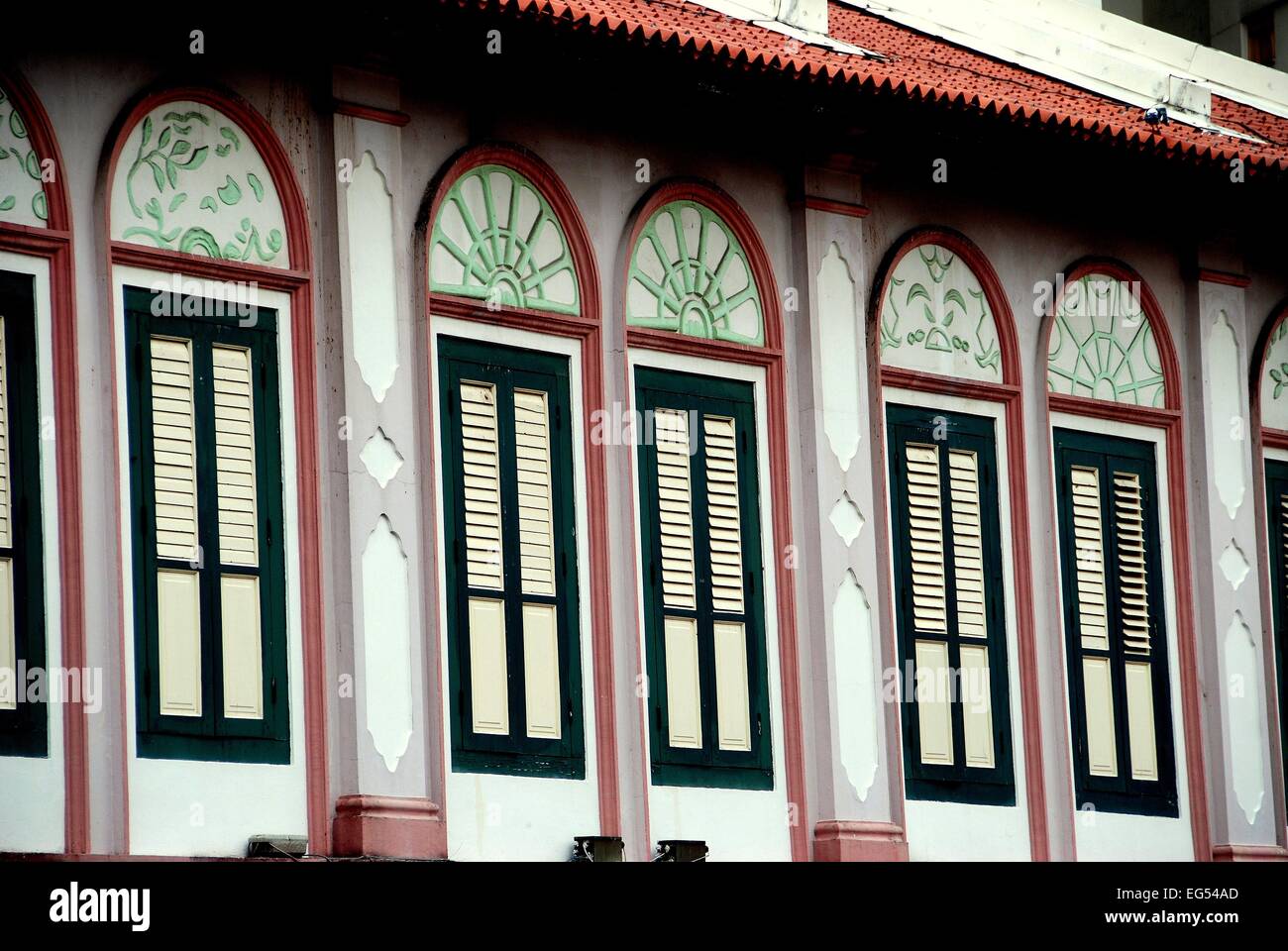 Singapore: Arched windows with wooden louvered shutters adorn the ...