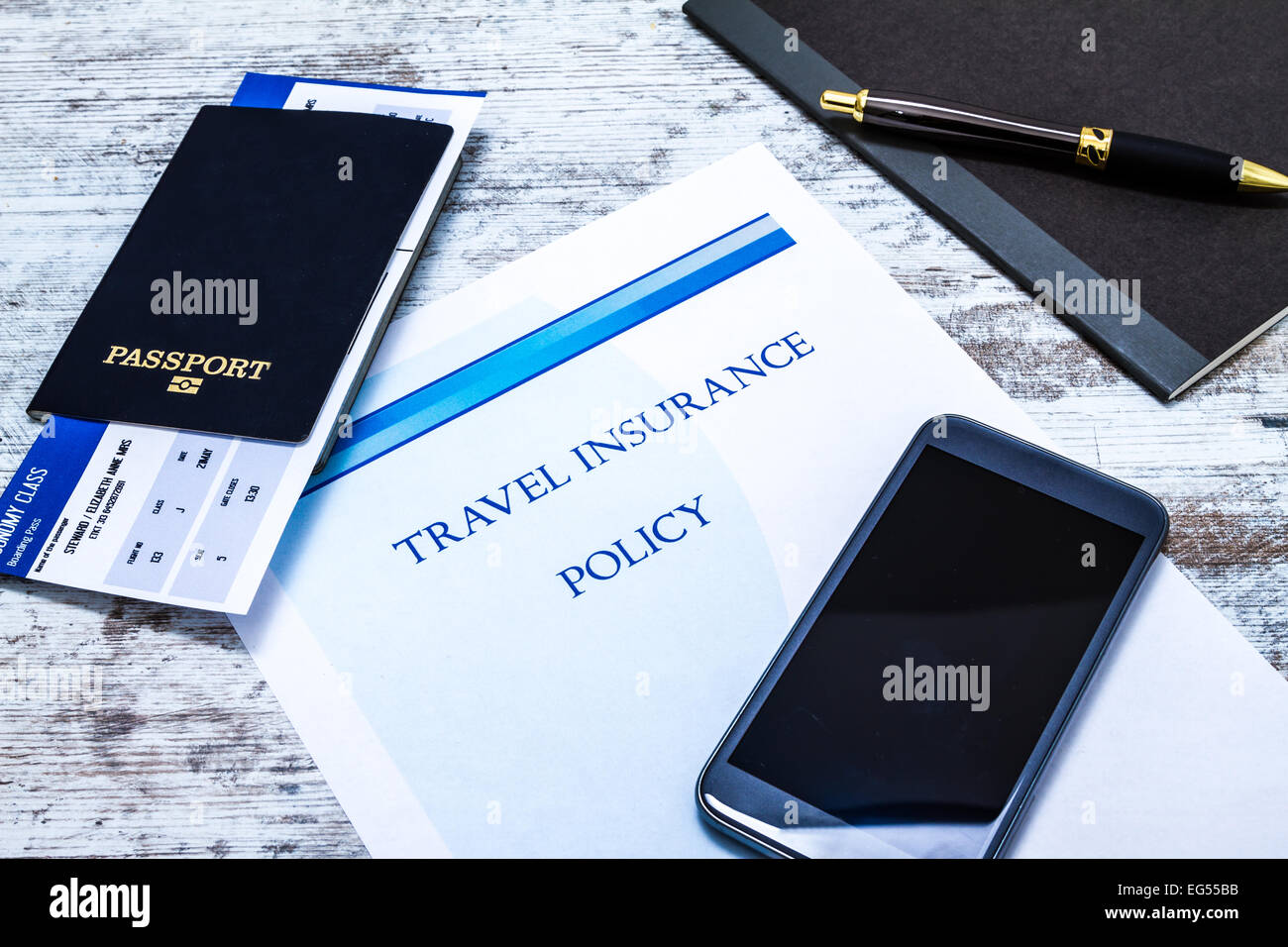Travel insurance policy booklet with a boarding pass and a passport ...