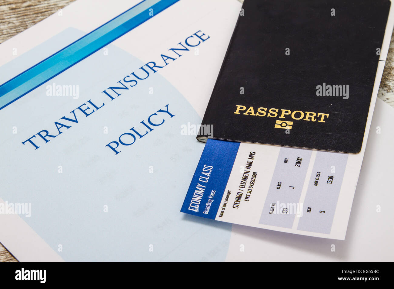 Travel insurance policy booklet with a boarding pass and a passport ...