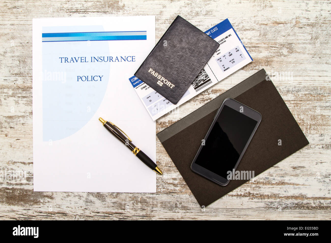 Travel insurance policy booklet with a boarding pass and a passport ...