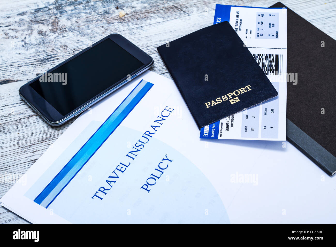 Travel insurance policy booklet with a boarding pass and a passport ...