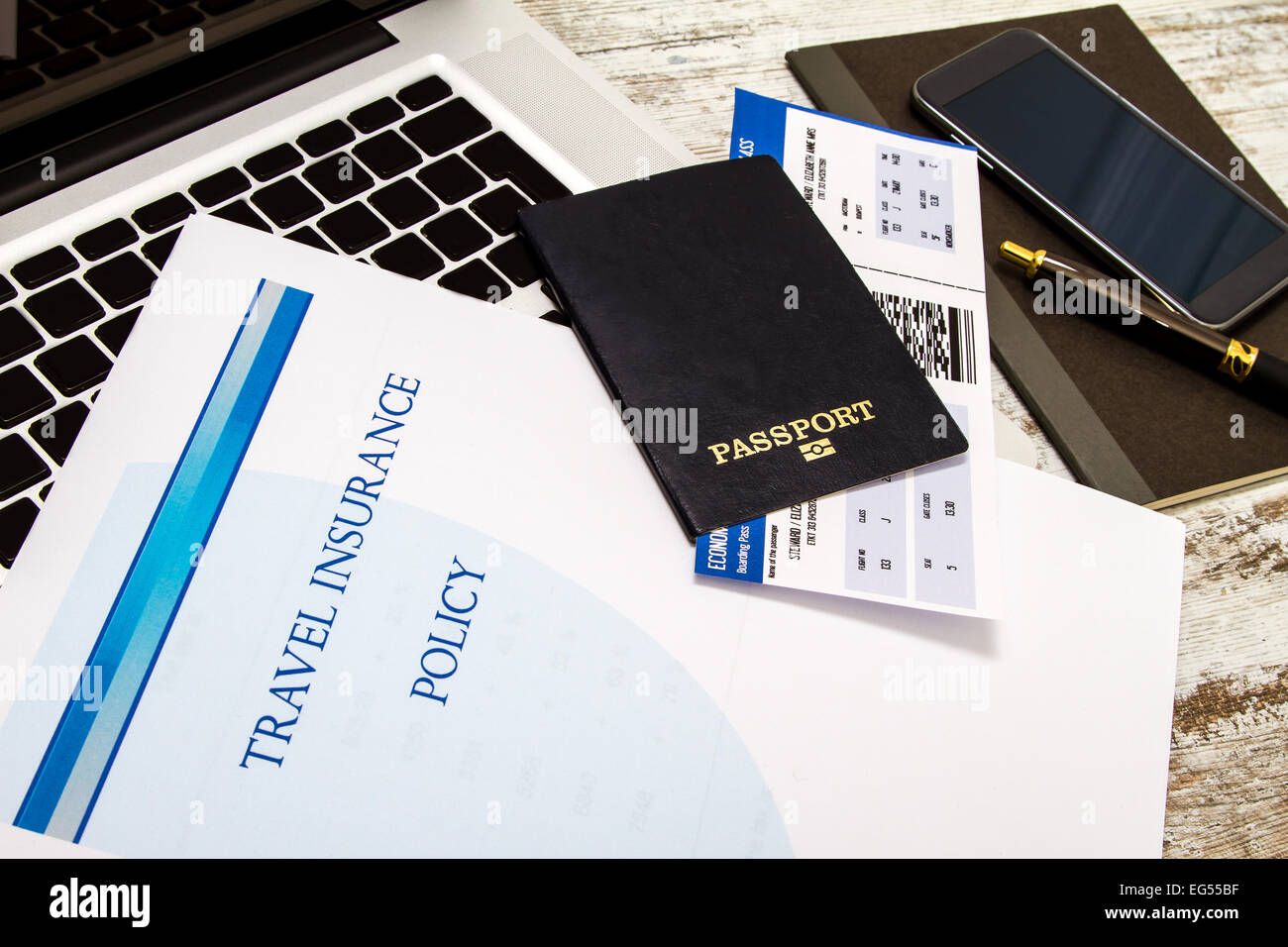 Travel insurance policy booklet with a boarding pass and a passport ...