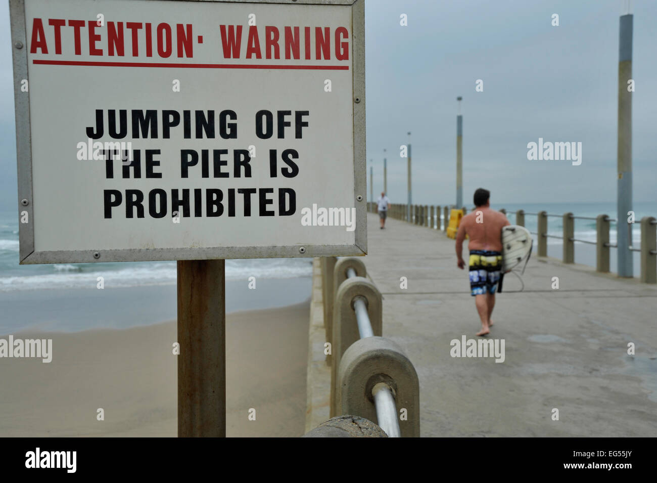 People Walking Past Warning Sign High Resolution Stock Photography and ...