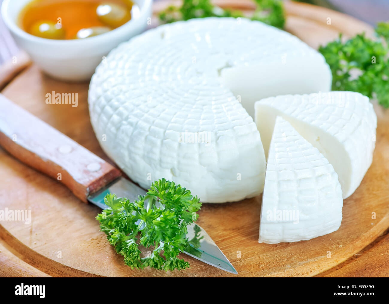 round cheese and aroma spice on wooden board Stock Photo - Alamy