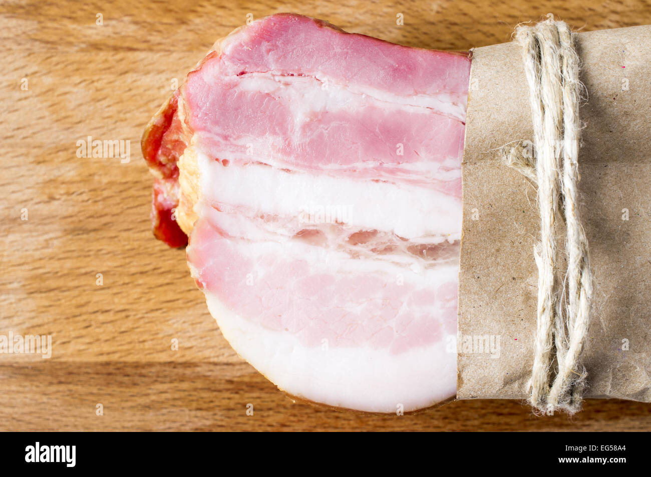 Smoked bacon in one piece of paper packaging Stock Photo - Alamy