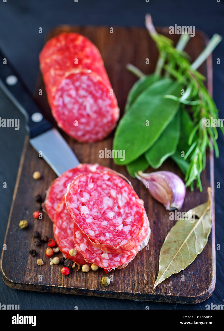 salami and knife, salami on black table Stock Photo - Alamy