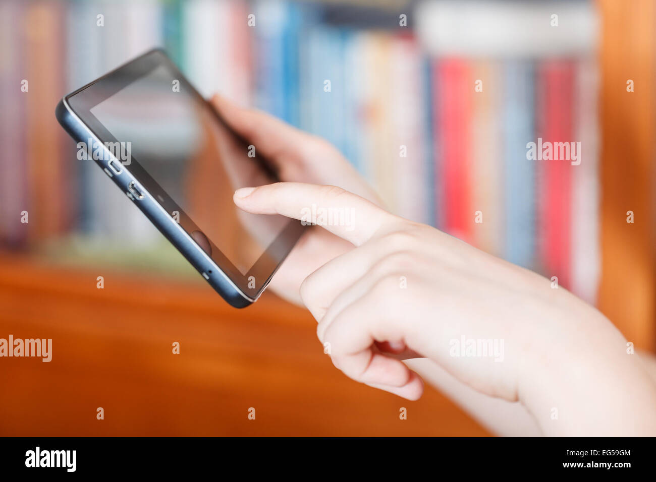 girl touching tablet pc screen in living room Stock Photo - Alamy