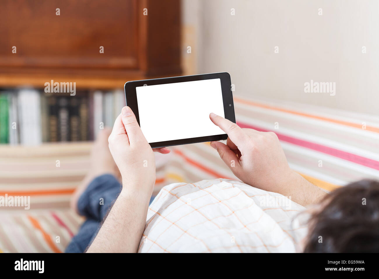 man reading with tablet pc with cut out screen in living room Stock ...