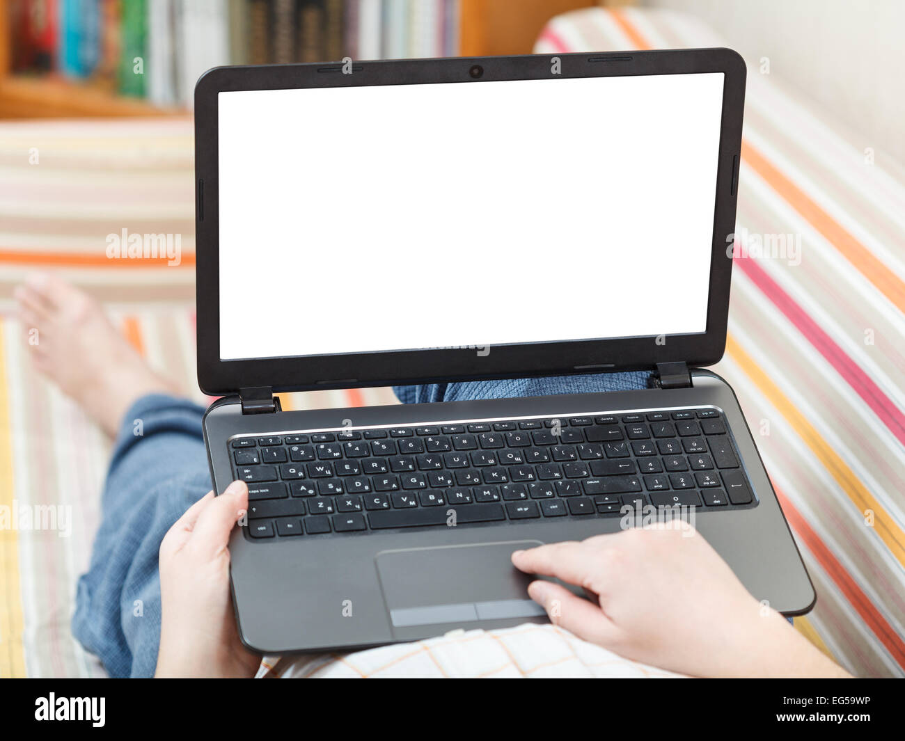 man works on laptop with cut out screen in living room Stock Photo - Alamy