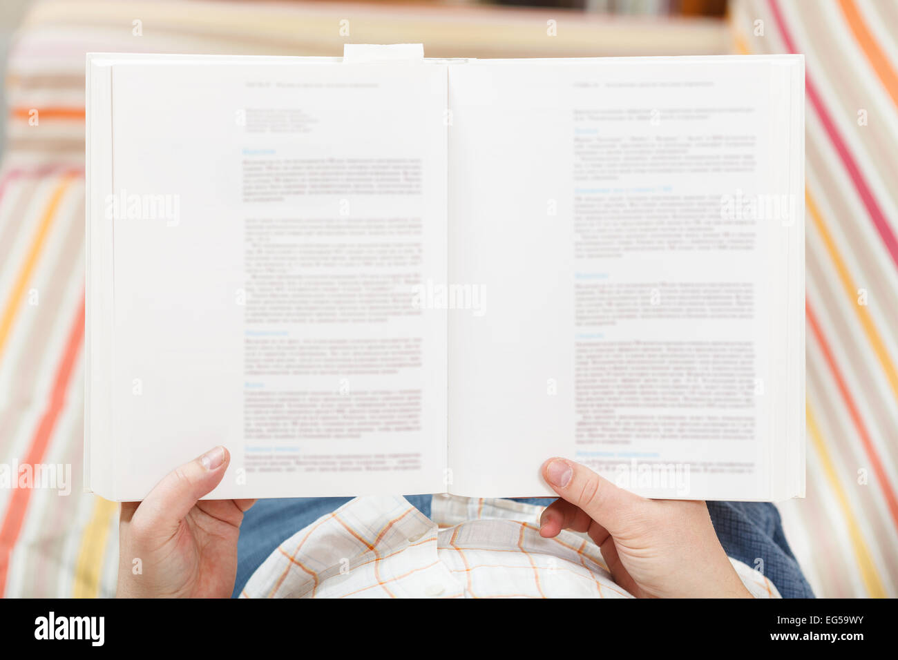 man read book with blurred text in living room Stock Photo - Alamy