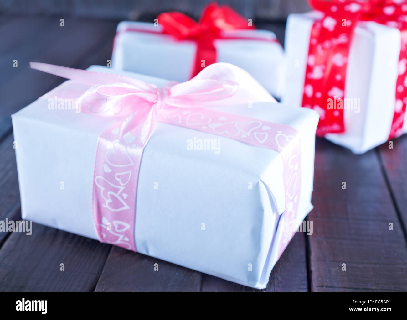 boxes for present with ribbon on a table Stock Photo - Alamy