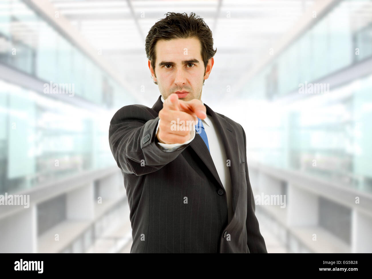 young business man in a suit pointing at the office Stock Photo - Alamy