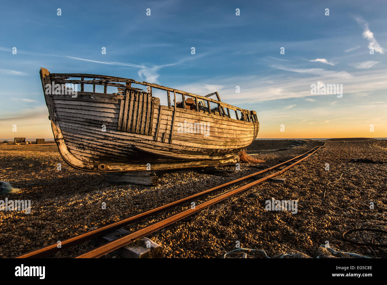 Off The Rails. An old fishing boat on Dungeness beach Kent, beside and ...