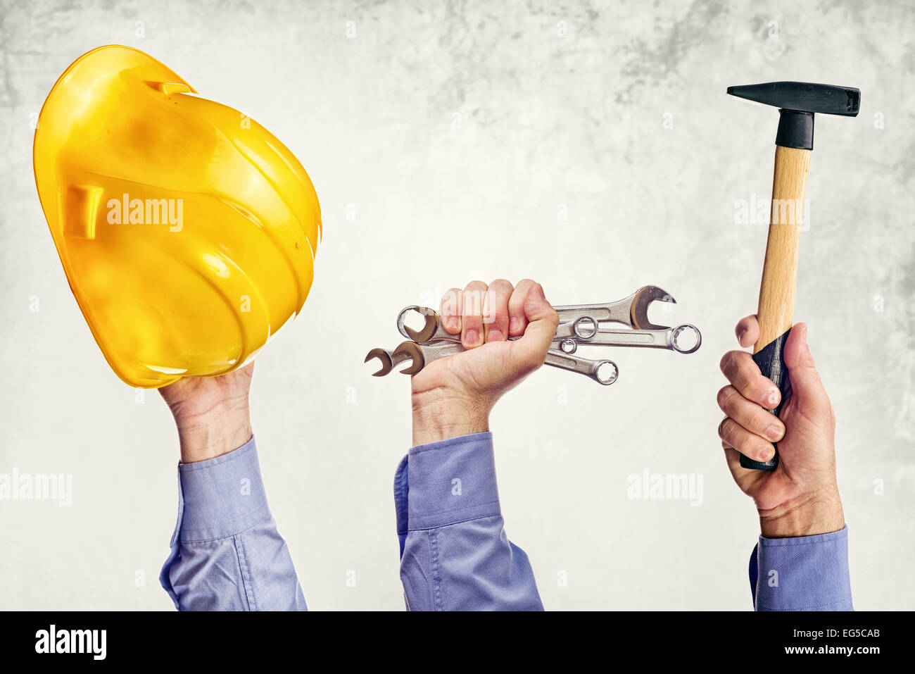 Male worker's hand holding various crafts trade tools. Part of series ...