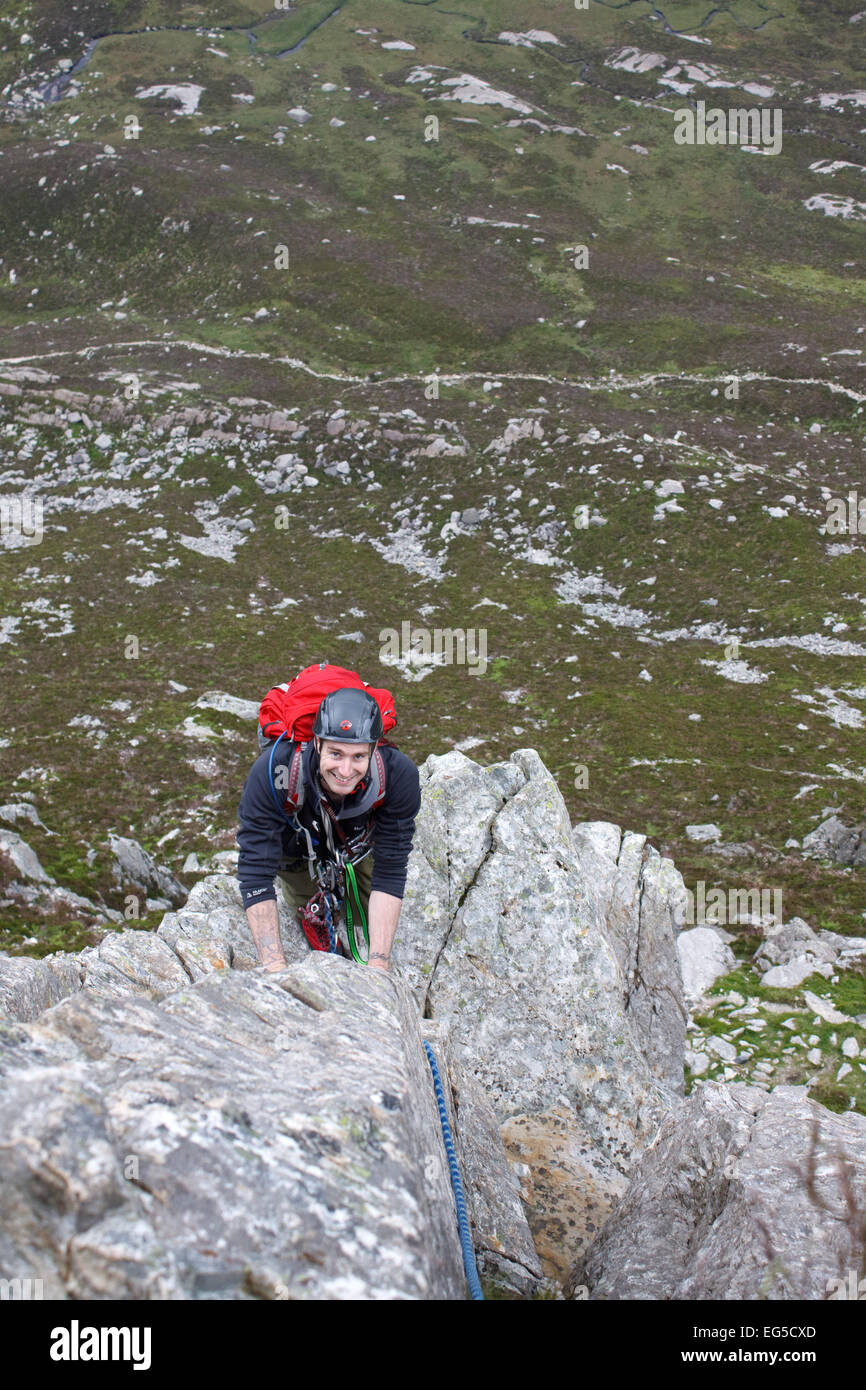 A male rock climber enjoying the climb First Pinnacle Rib on the ...