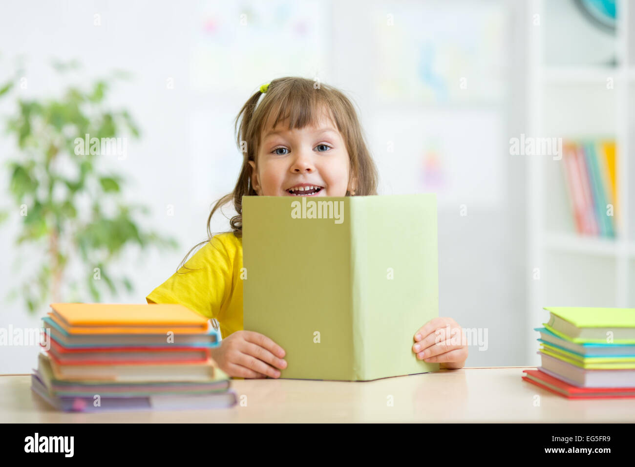 kid girl with open book Stock Photo - Alamy