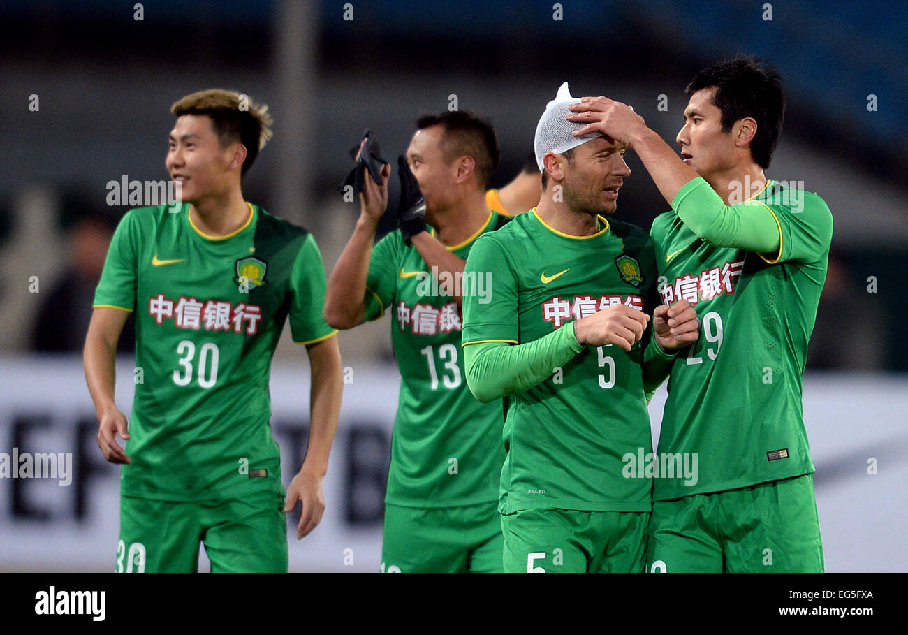 Beijing, R) of China's Beijing Guoan FC checks Matic's wound after ...