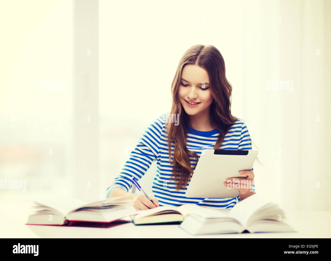 smiling student girl with tablet pc and books Stock Photo - Alamy