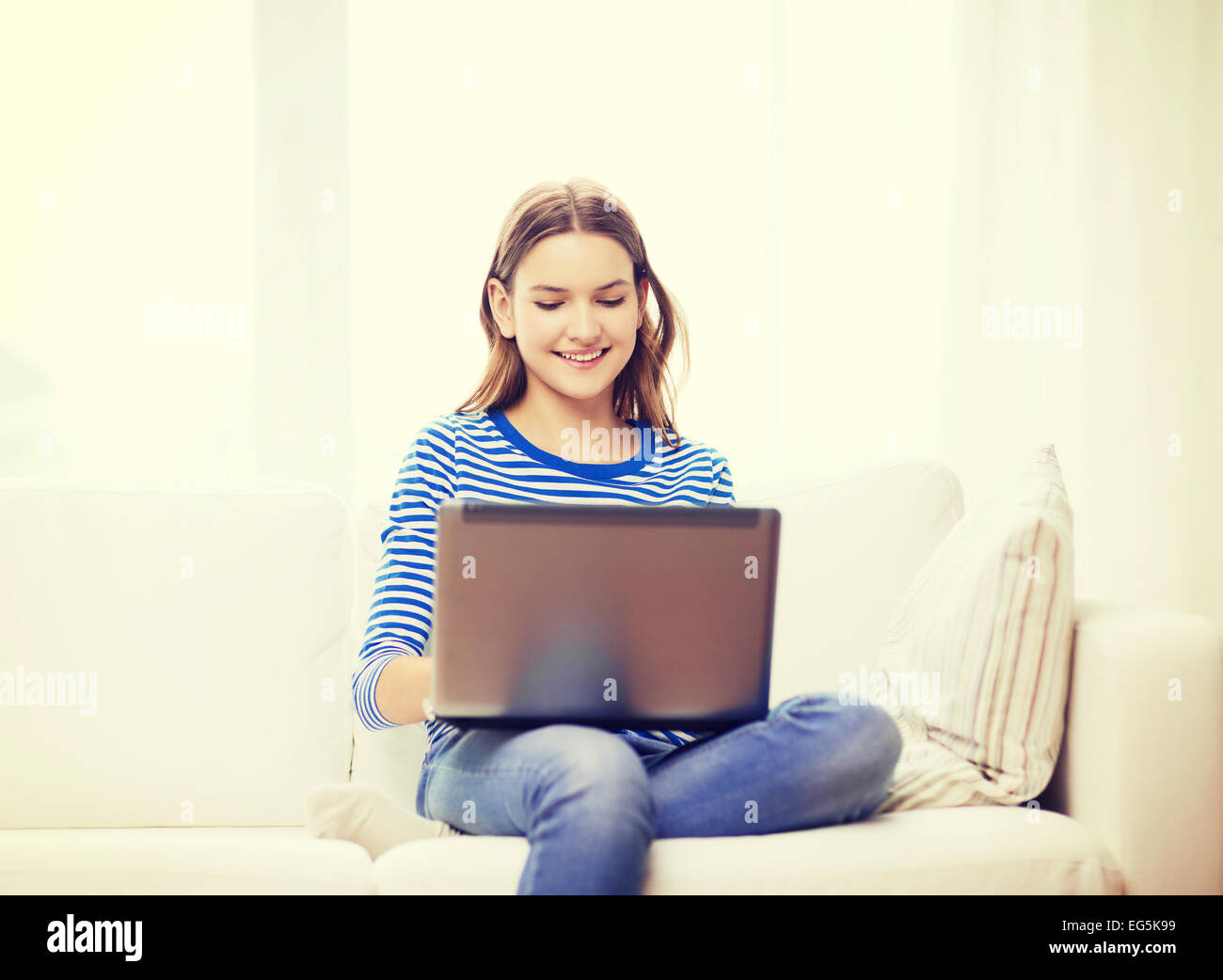 smiling teenage girl with laptop computer at home Stock Photo - Alamy