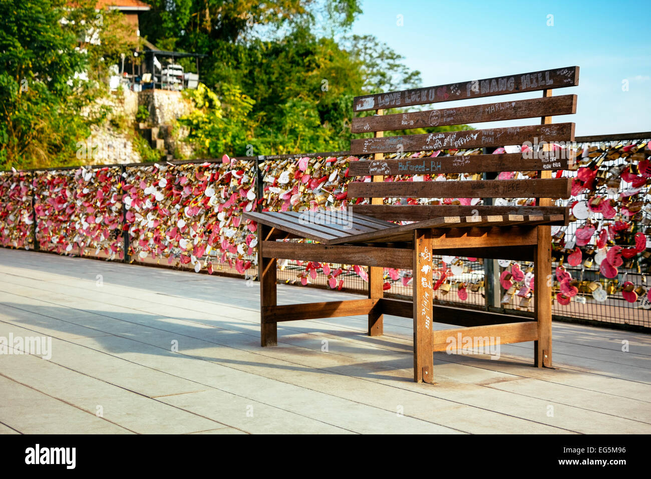 Wooden bench with writings and love locks Stock Photo - Alamy