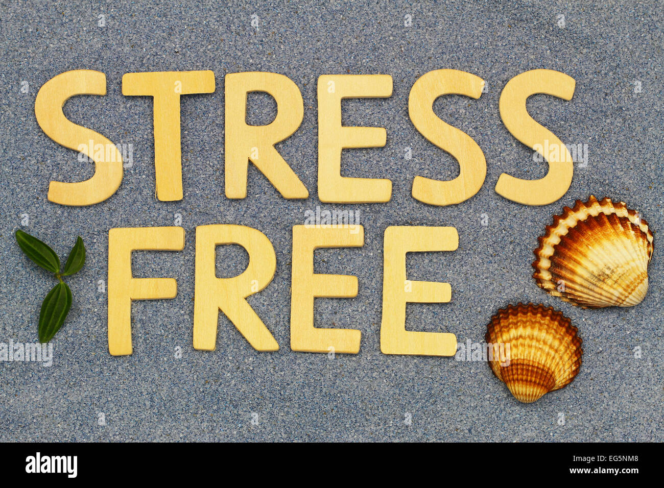 Stress free written with wooden letters on blue sand Stock Photo - Alamy