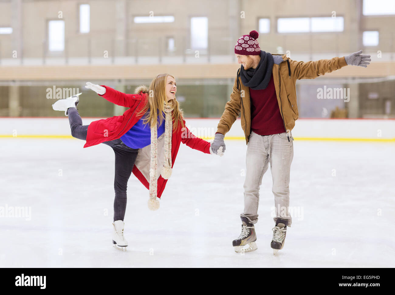 happy couple holding hands on skating rink Stock Photo - Alamy