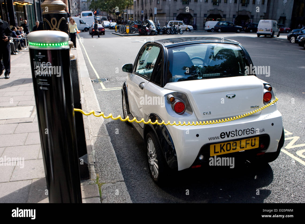 An Electric powered mini car parked in a battery charging bay in ...