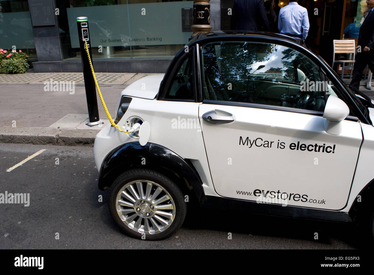 An Electric powered mini car parked in a battery charging bay in ...