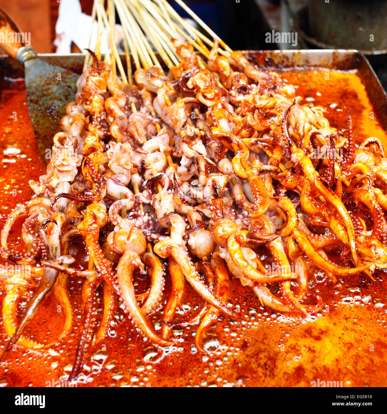 Frying of squid's tentacles skewers in Shanghai, China Stock Photo - Alamy