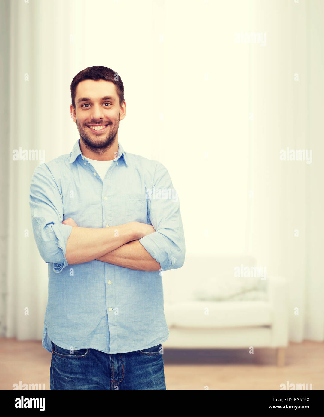 smiling man with crossed arms Stock Photo - Alamy