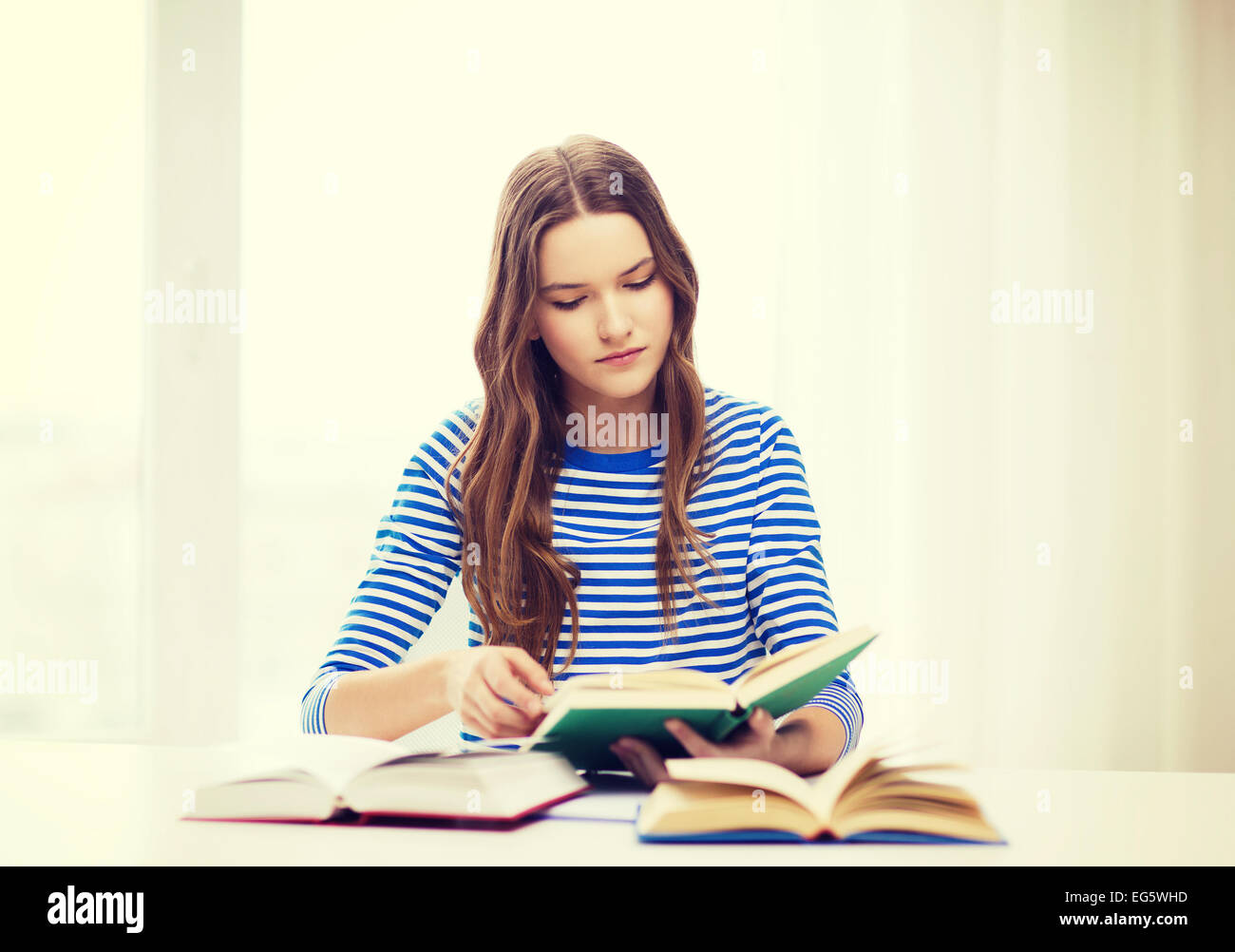 concentrated student girl with books Stock Photo - Alamy