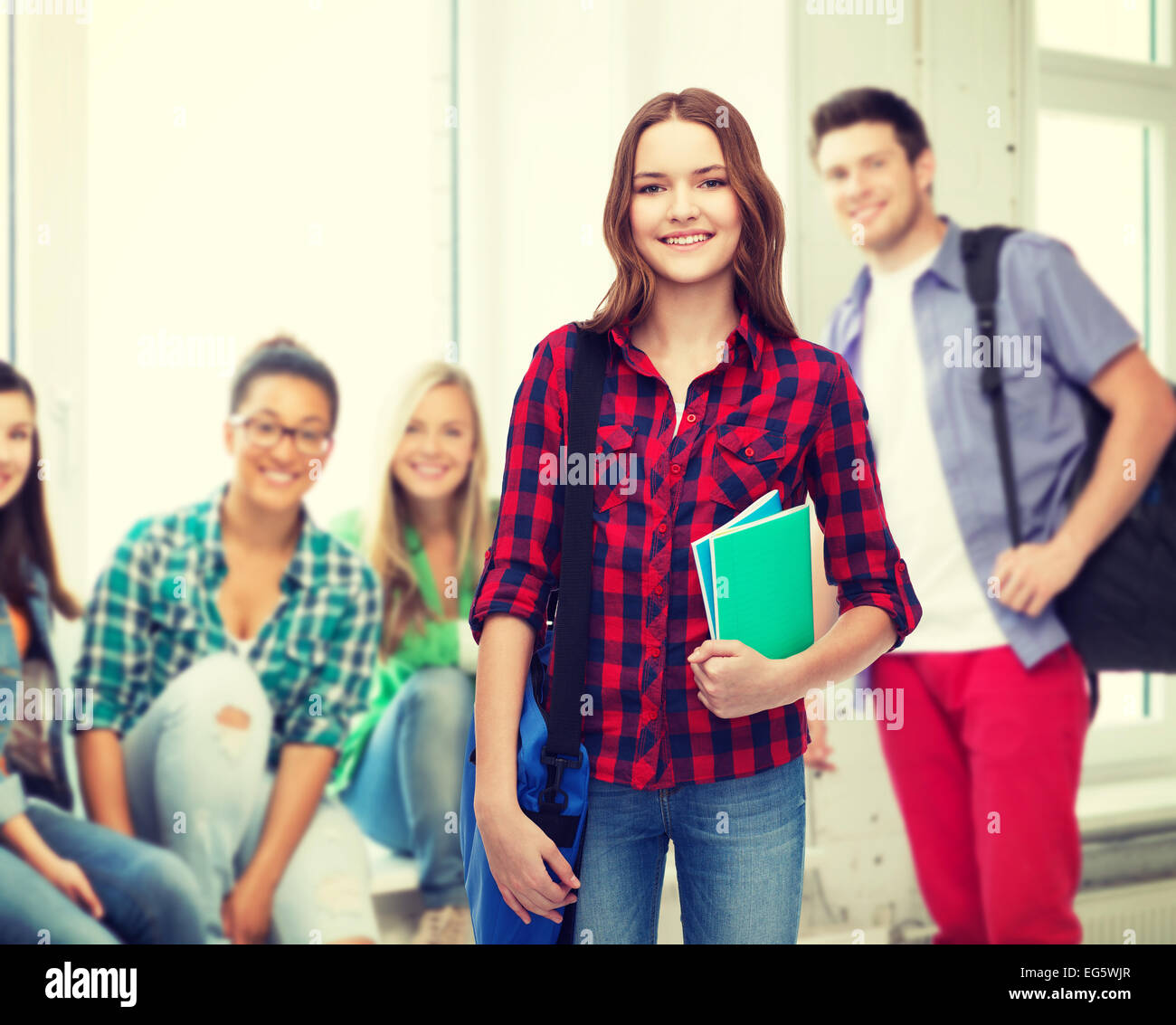 smiling female student with bag and notebooks Stock Photo - Alamy