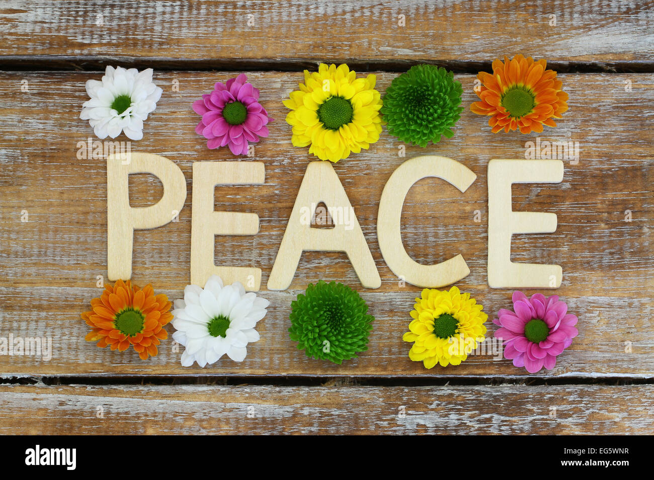 Peace written with wooden letters on rustic wood and colorful Santini ...