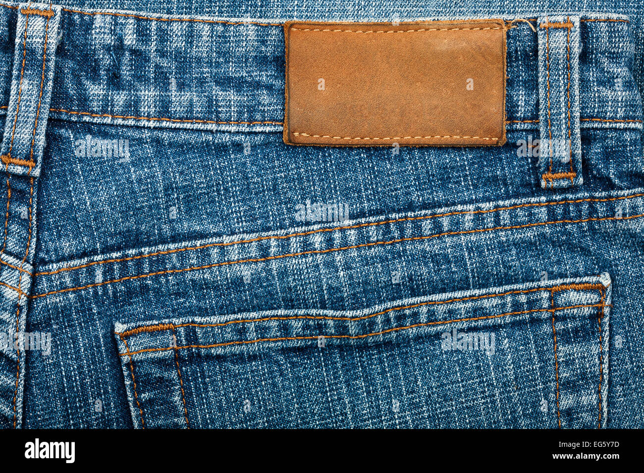 Blank leather jeans label sewed on a blue jeans Stock Photo - Alamy