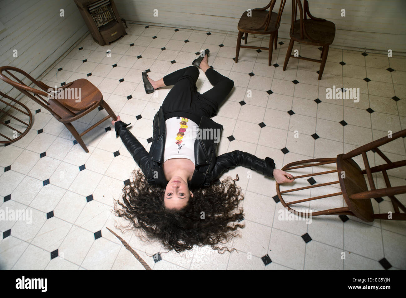 Girl Lying On Floor With Overturned Chairs Stock Photos & Girl Lying On ...