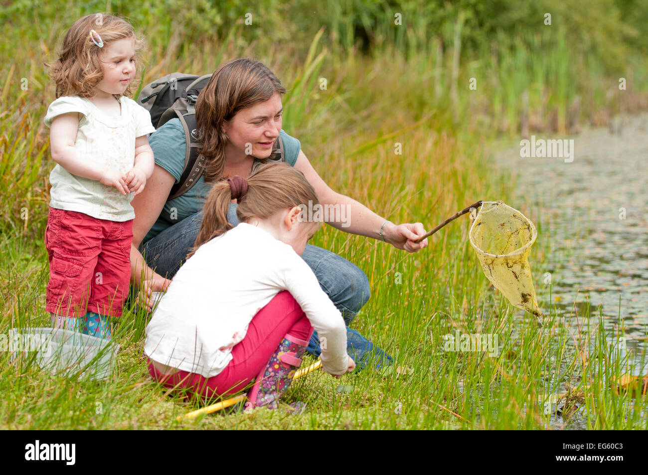 Children and mother pond dipping and enjoying pond environment at ...