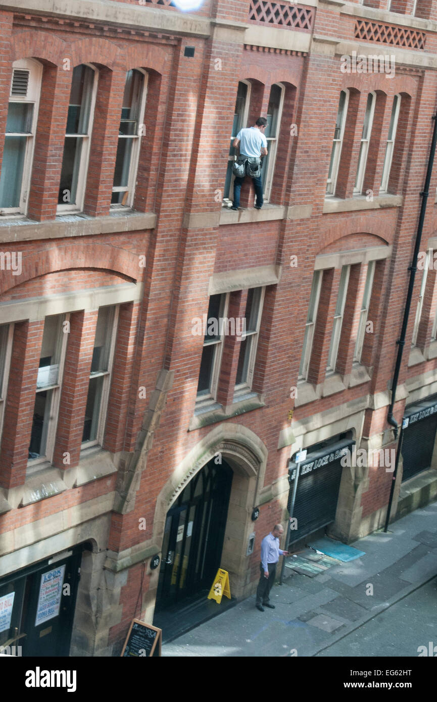 Man climbing out of window hi-res stock photography and images - Alamy