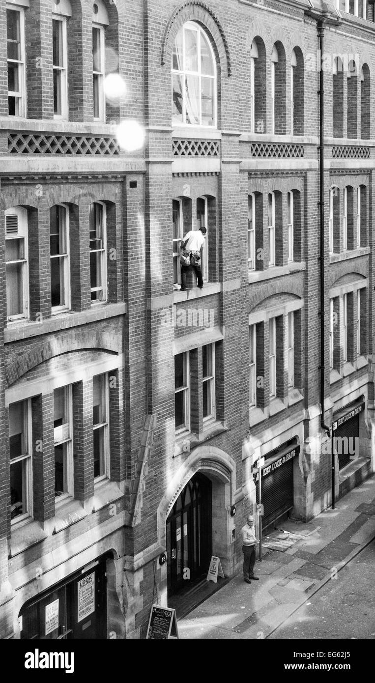Man climbing out of window hi-res stock photography and images - Alamy