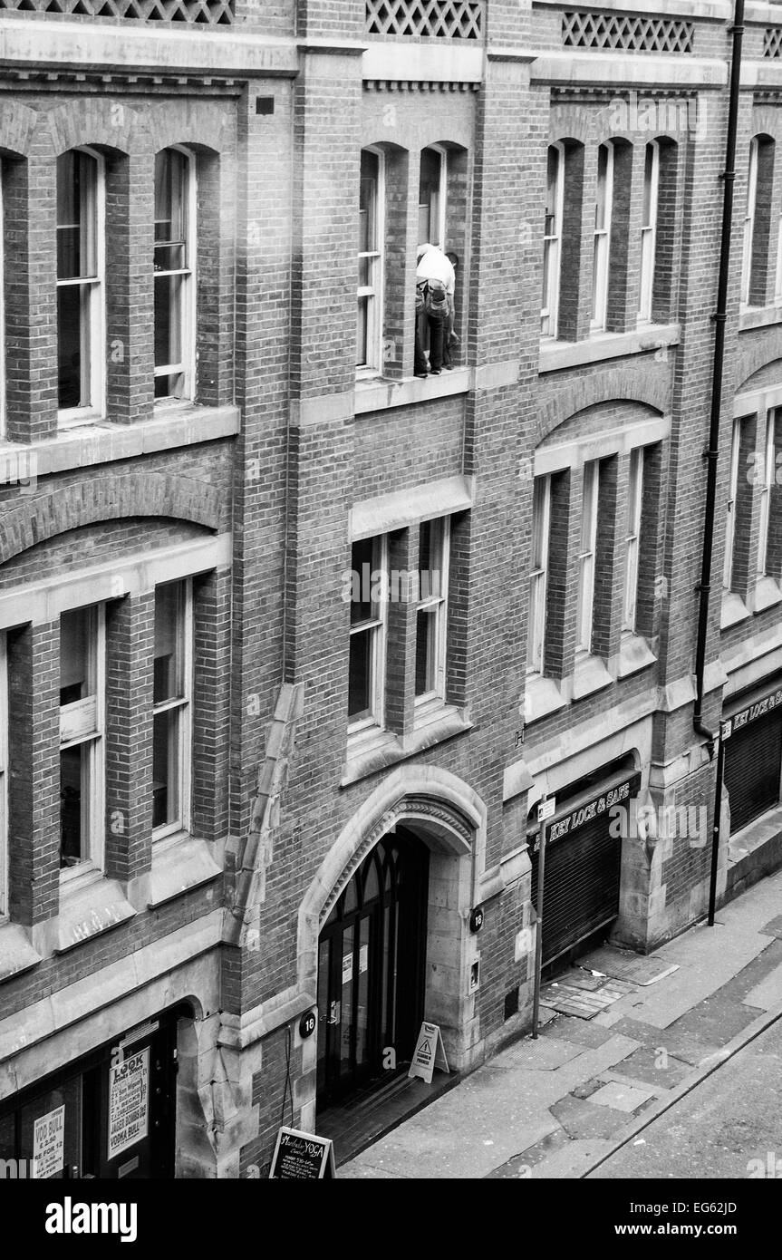Man climbing out of window hi-res stock photography and images - Alamy