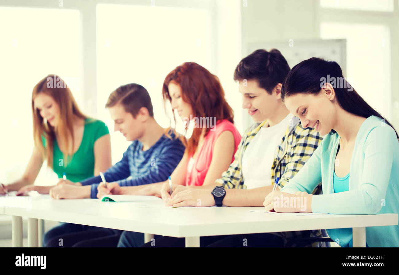 smiling students with textbooks at school Stock Photo - Alamy