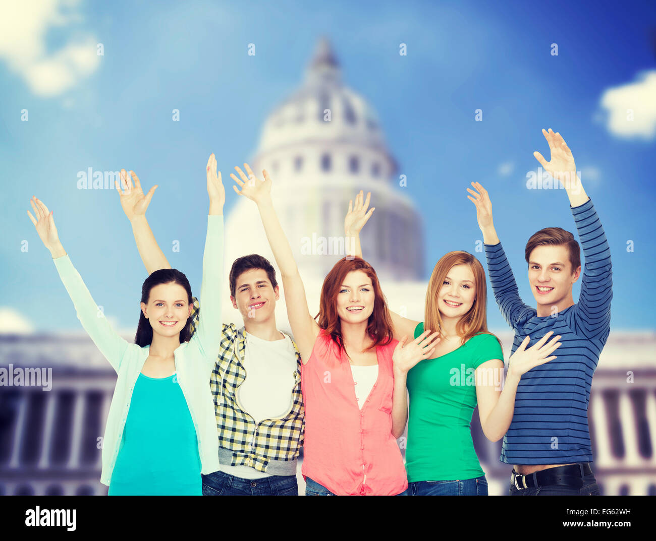 group of smiling students waving hands Stock Photo - Alamy