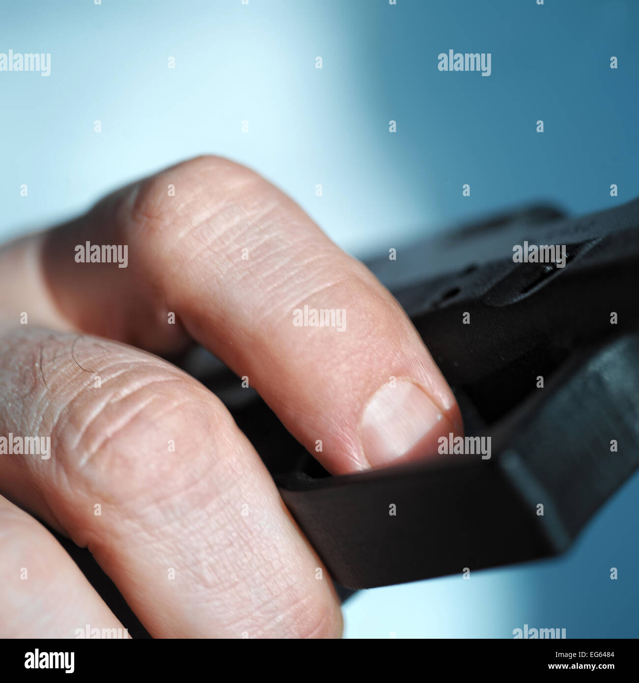 Male Hand on a Gun Trigger Stock Photo - Alamy