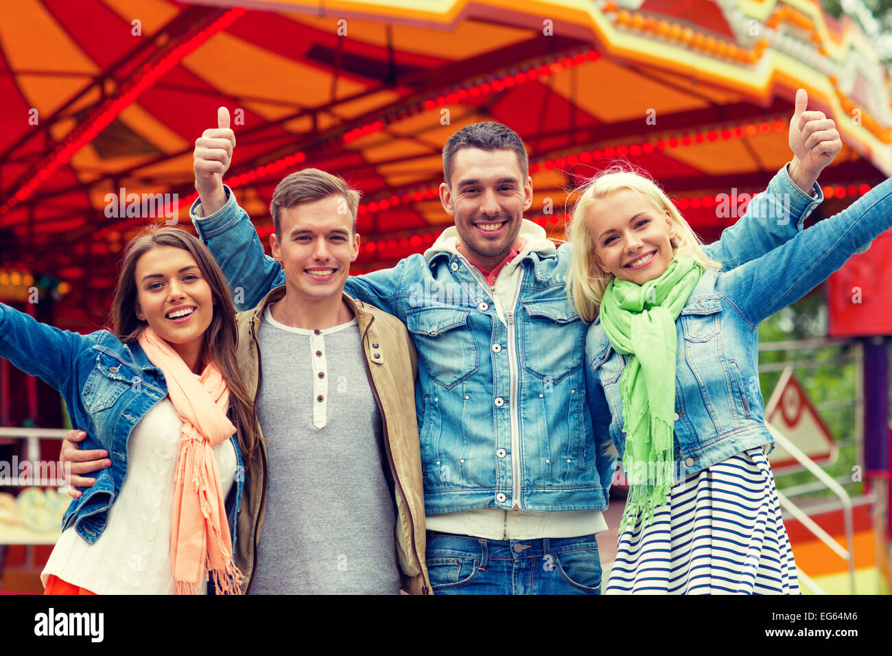 group of smiling friends showing thumbs up Stock Photo - Alamy