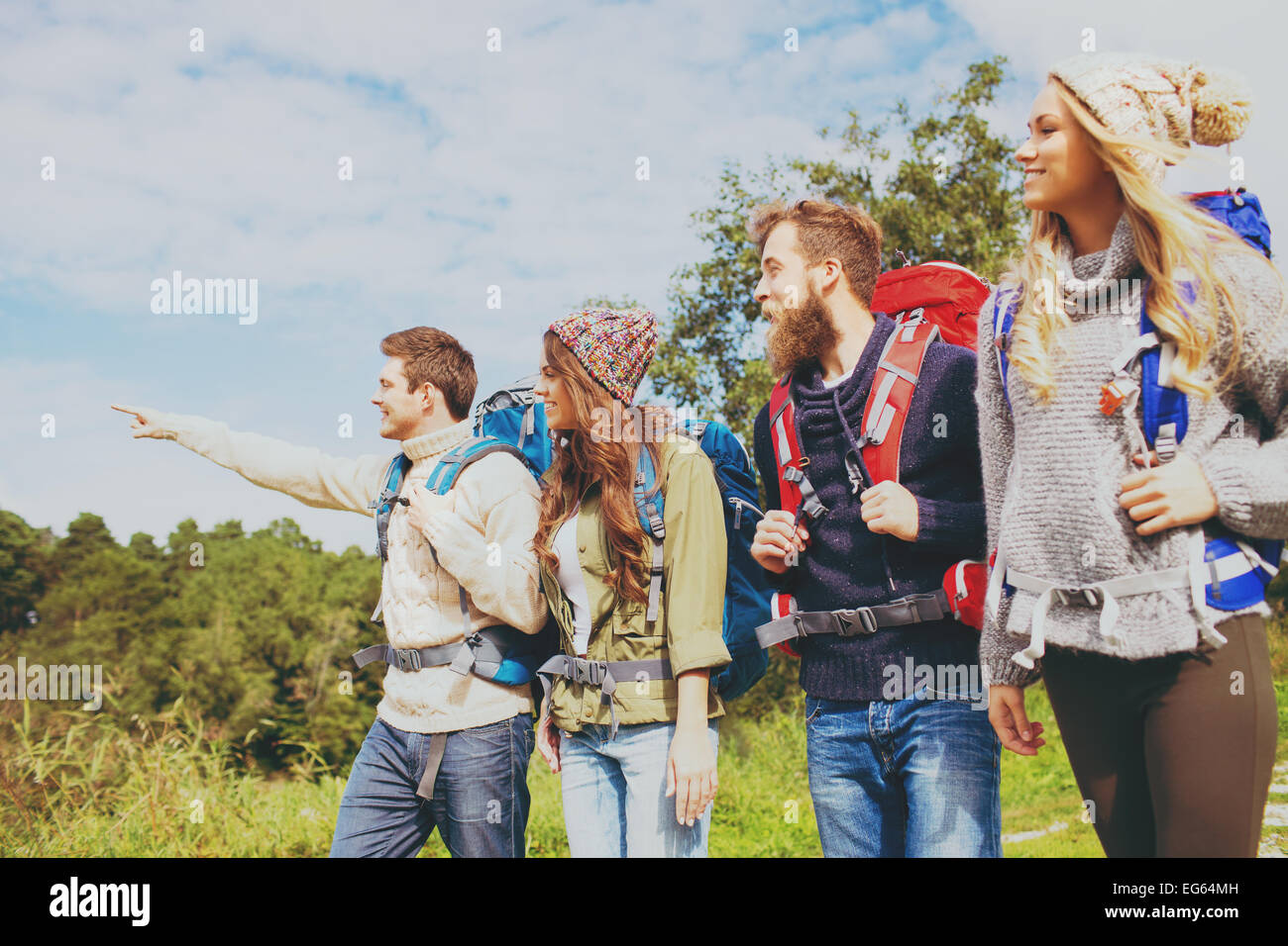 group of smiling friends with backpacks hiking Stock Photo - Alamy