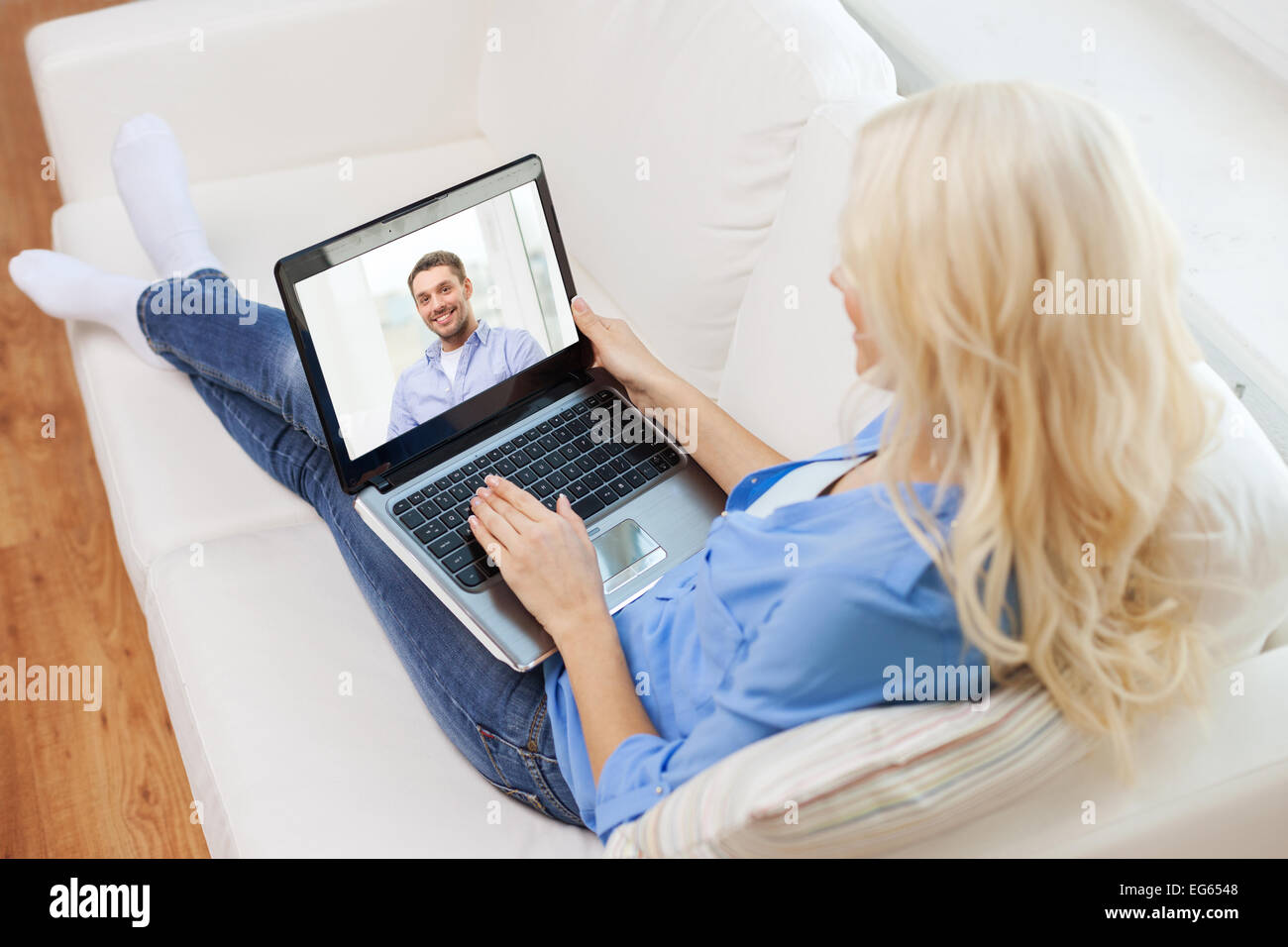 smiling woman with laptop computer at home Stock Photo - Alamy