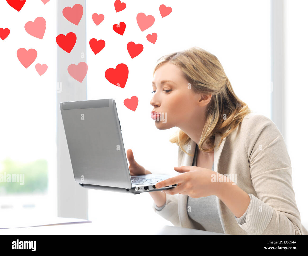 woman sending kisses with laptop computer Stock Photo - Alamy