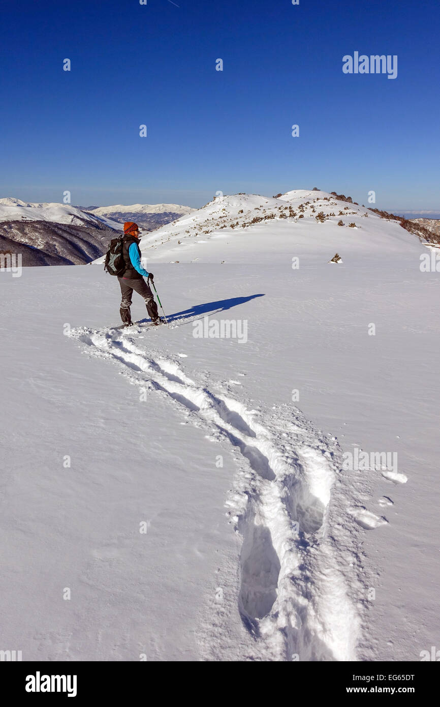 Female snowshoeing in fresh deep snow, Plateau de Beille, Pyrenees ...