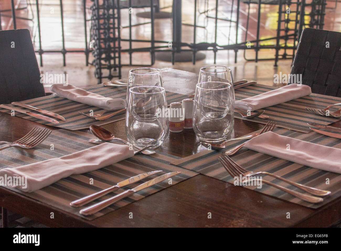 Four place settings at a table in a nice restaurant Stock Photo - Alamy