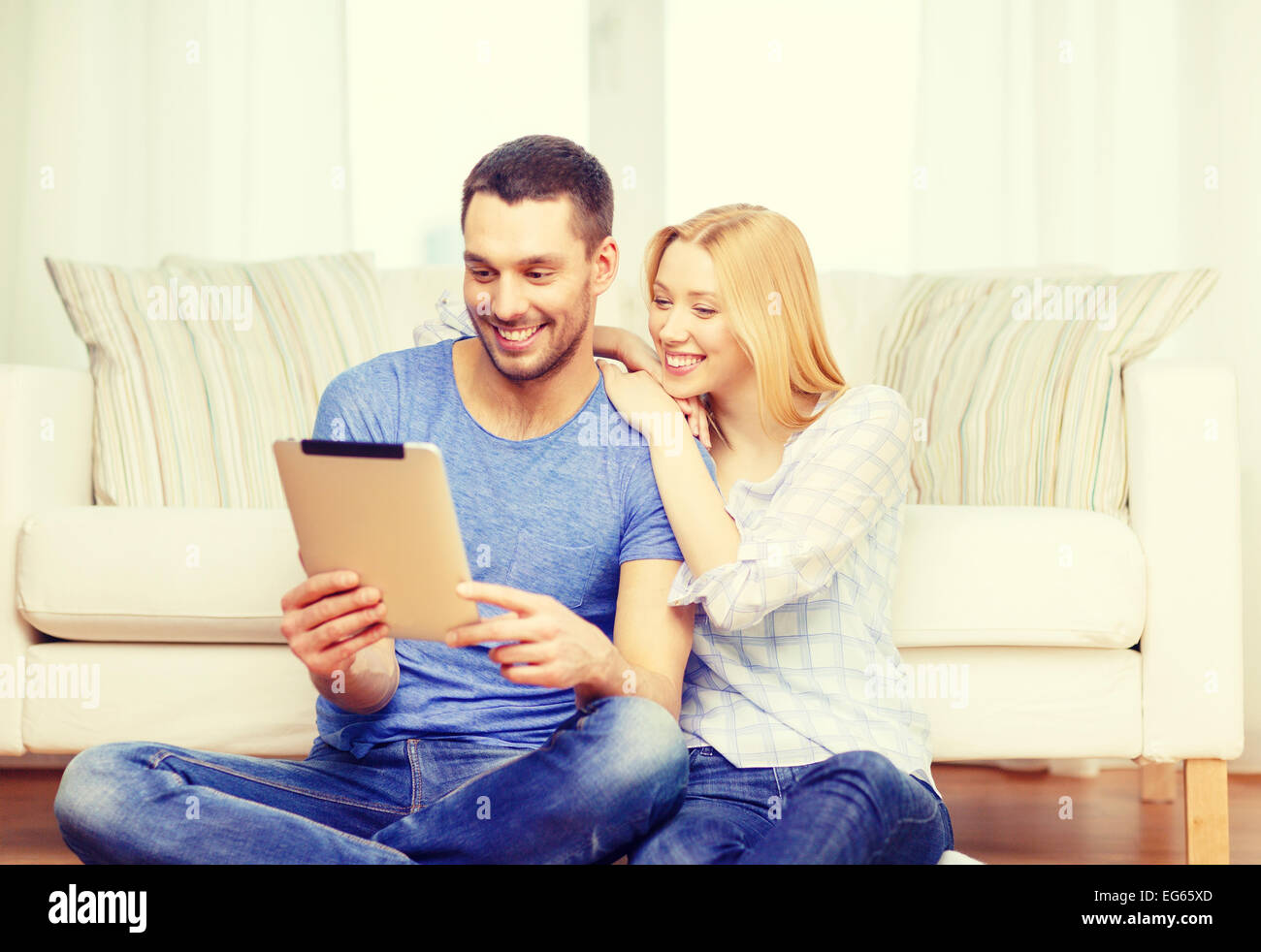 smiling happy couple with tablet pc at home Stock Photo - Alamy