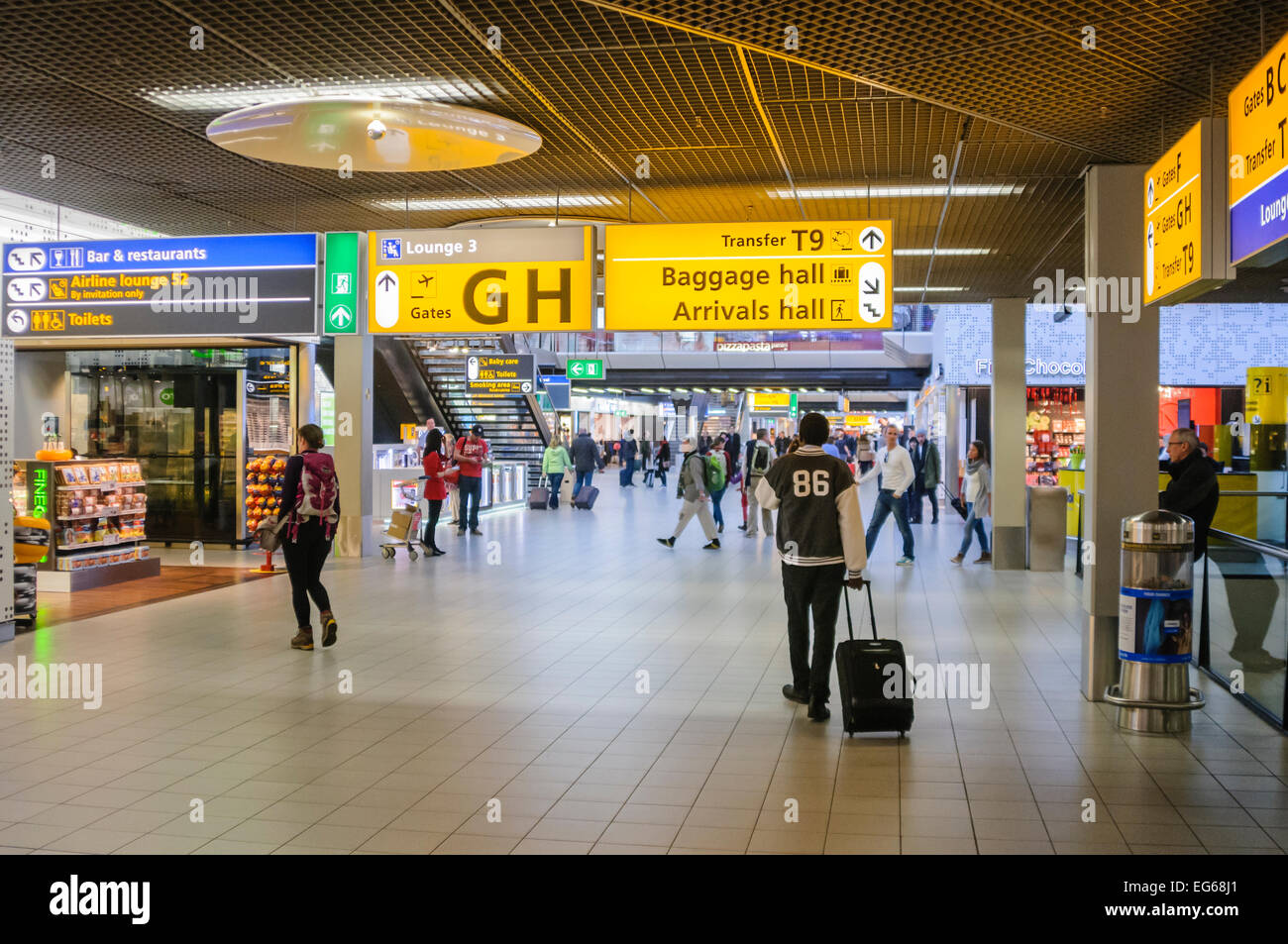 People walk towards the departure gates at an airport Stock Photo - Alamy
